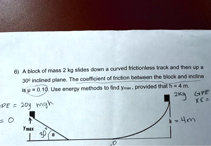 SOLVED: A block of mass 2 kg slides down a curved frictionless track ...
