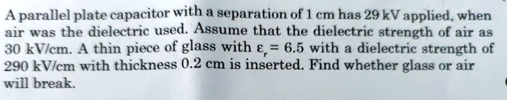 A parallel plate capacitor with a separation of 1 cm has 29 kV applied ...
