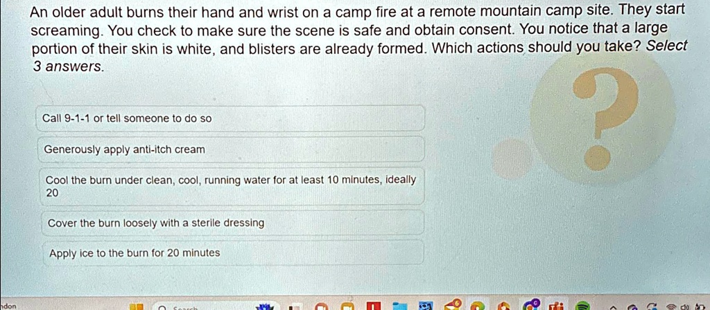 An older adult burns their hand and wrist on a camp fire at...