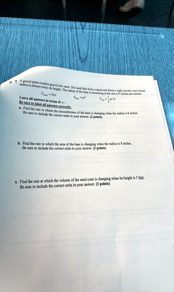 a gravel plant crushes gravel into sand the sand falls from a spout and ...