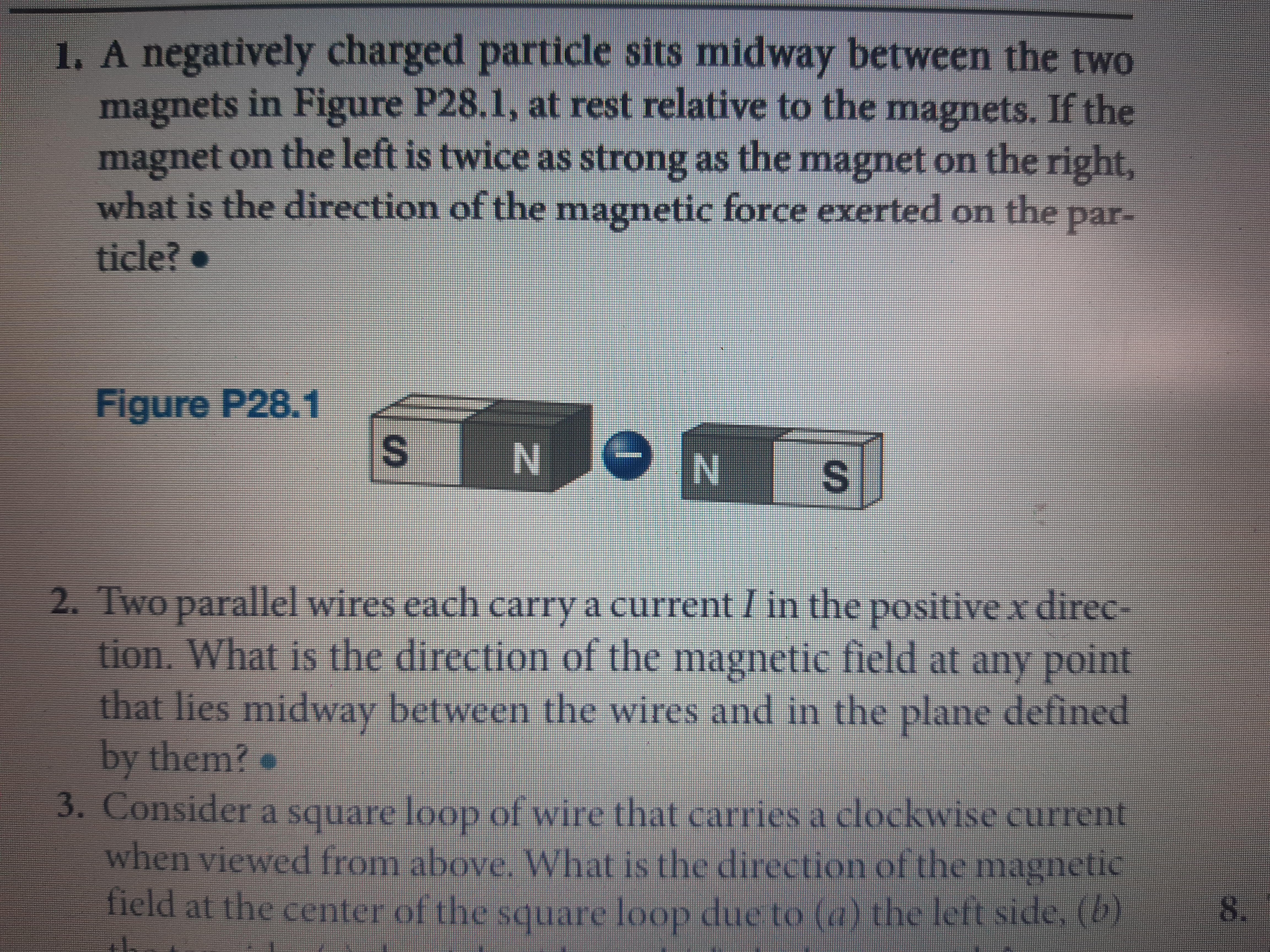 SOLVED: A negatively charged particle sits midway between the two ...