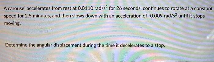 A carousel accelerates from rest at 0.0110 rad/s² for 26 seconds ...
