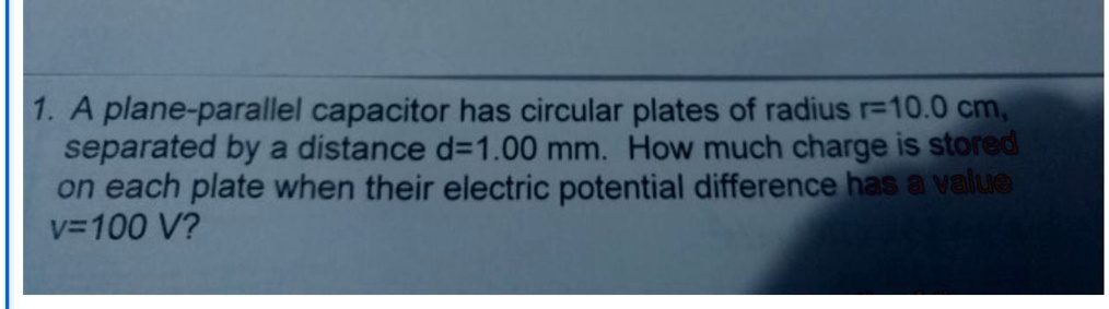 A plane-parallel capacitor has circular plates of radius r = 10.0 cm ...
