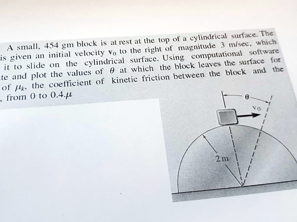 SOLVED: A small, 454 gm block is at rest at the top of a cylindrical surface.The is given an ...